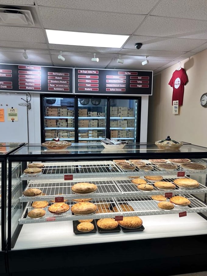 Pie paradise awaits! The display case at Just Pies showcases their daily offerings like a museum of edible masterpieces.