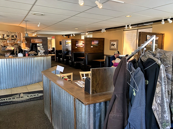 Step inside to corrugated metal accents and wooden booths where comfort meets mountain charm. The coat rack stands ready for your winter layers or hiking gear.