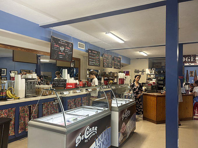 Inside, the blue walls and vintage ice cream counter create that perfect small-town diner atmosphere where calories don't count and conversations flow as freely as the coffee.