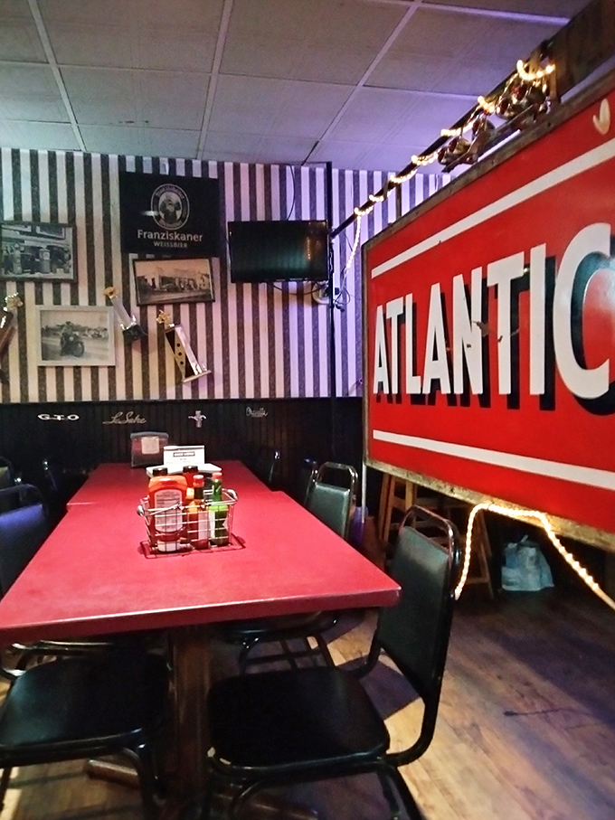 The striped walls and vintage Atlantic sign scream "authentic roadhouse" &ndash; not the kind designed by corporate suits with clipboards and focus groups.