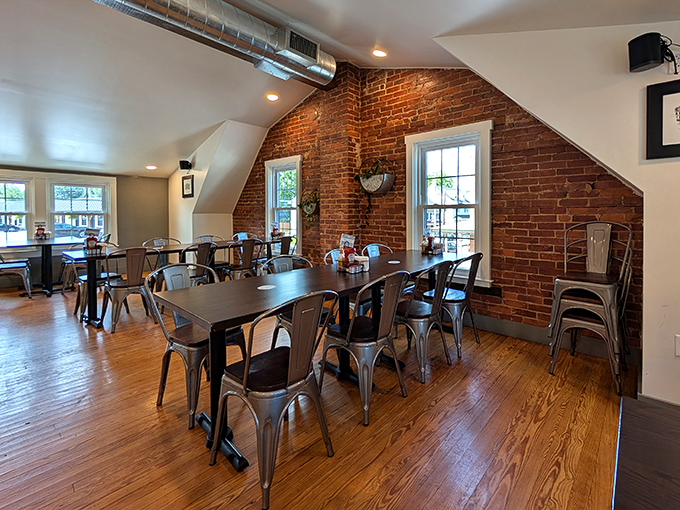 Exposed brick meets honey-colored wood in this upstairs dining area. The metal chairs say "modern," but the sloped ceiling whispers "come stay awhile."