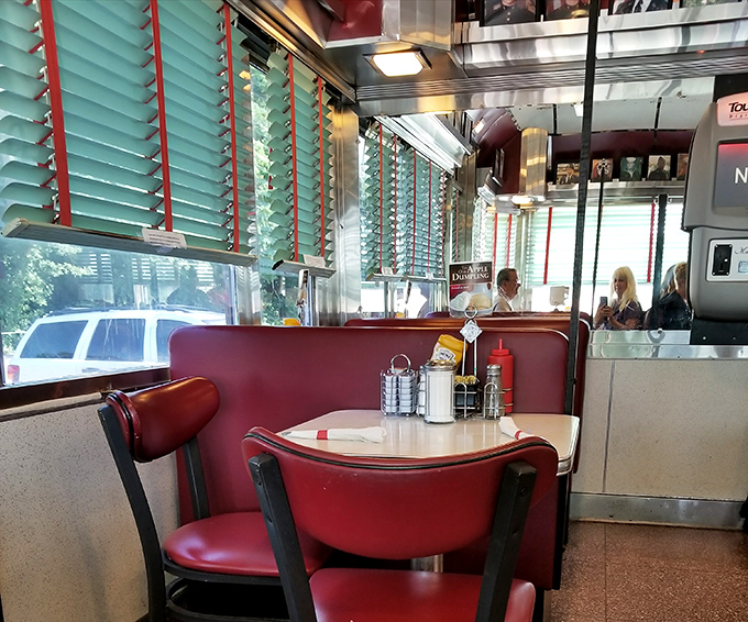 Where conversations flow as freely as the coffee. These cherry-red booths have witnessed first dates, family reunions, and countless "just one more bite" moments.