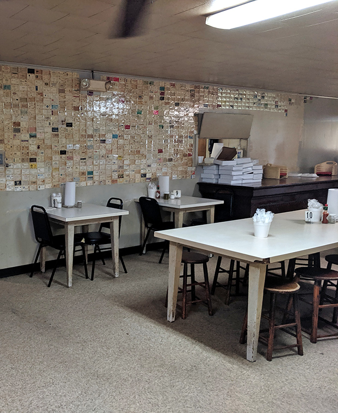 Business cards blanket the walls like edible confetti, each one a testimonial to ribs that changed lives.