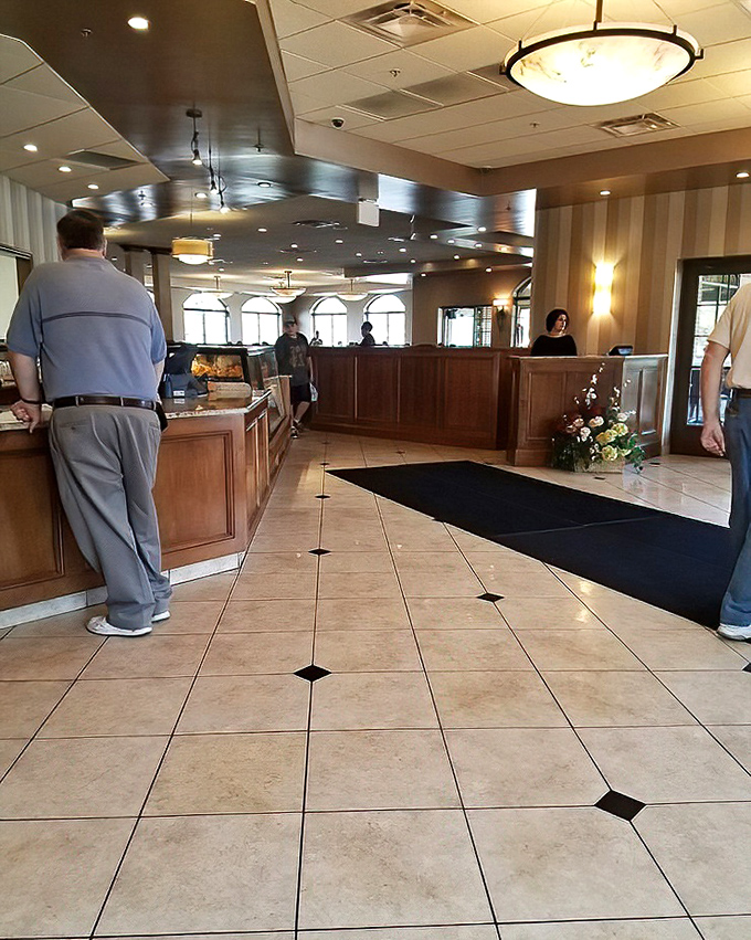 The warm interior welcomes you with polished wood, elegant tile floors, and that unmistakable deli counter where sandwich dreams come true.