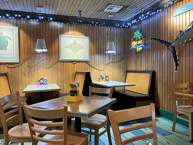 Wood-paneled walls adorned with marine artwork and string lights create that perfect "come as you are" atmosphere where memorable meals happen.