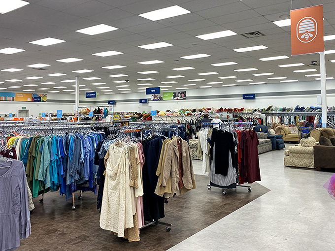 Inside, the vastness reveals itself. Racks upon racks of clothing stretch toward the horizon like a textile sea waiting to be navigated.