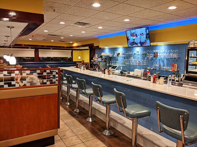 Classic diner counter magic: where blue-tiled charm meets the satisfying spin of those timeless stools that practically whisper "stay awhile."