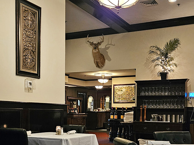 That mounted deer isn't judging your order—he's just jealous he can't join you. The elegant dining room balances old-school charm with white-tablecloth sophistication.