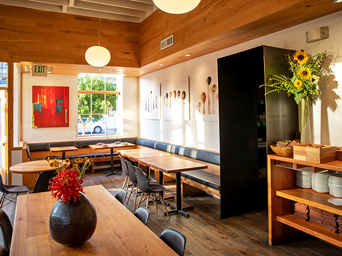 Warm wood meets modern minimalism inside Piccino, where globe lights cast a glow that makes everyone look like they're in a Nancy Meyers film.