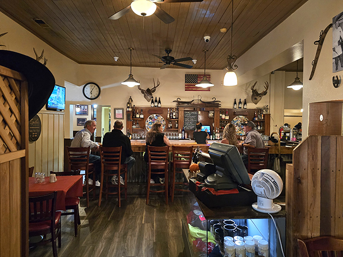 Step inside to find a classic steakhouse ambiance where mounted deer heads watch over patrons at the bar, and wood-paneled ceilings create the perfect backdrop for carnivorous adventures.