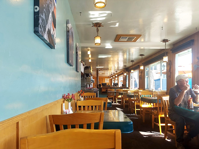 The interior speaks the universal language of coastal comfort &ndash; simple wooden chairs, blue walls, and the promise of seafood that was swimming this morning.