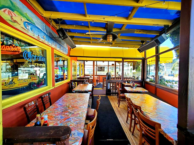 Inside, the vibrant blue ceiling and colorful tables create a cheerful maritime atmosphere that feels like dining inside a particularly delicious postcard.