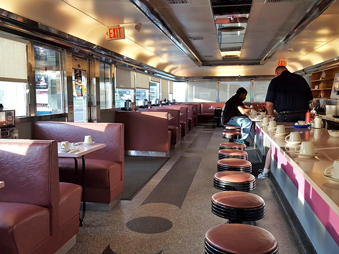 Inside, burgundy vinyl booths and counter seating create that perfect diner atmosphere where conversations flow as freely as the coffee.