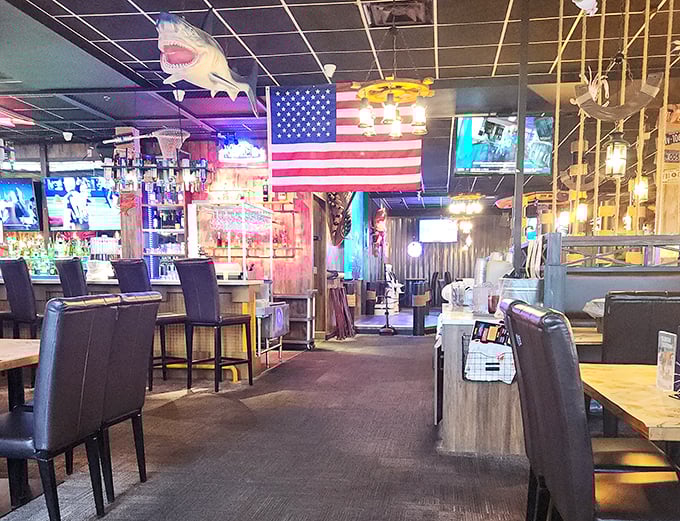 The interior blends nautical charm with sports bar comfort. That shark on the ceiling? He's just keeping an eye on your seafood.