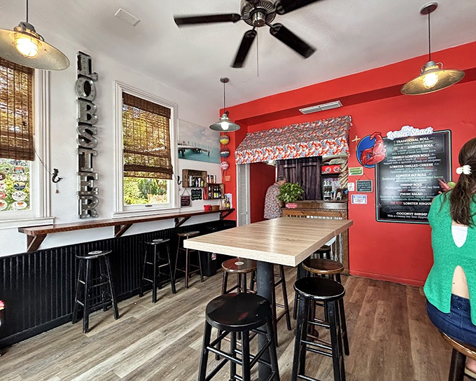Inside, vibrant red walls and industrial lighting create the perfect backdrop for seafood revelations. The "LOBSTER" sign ensures you'll never forget what brought you here.