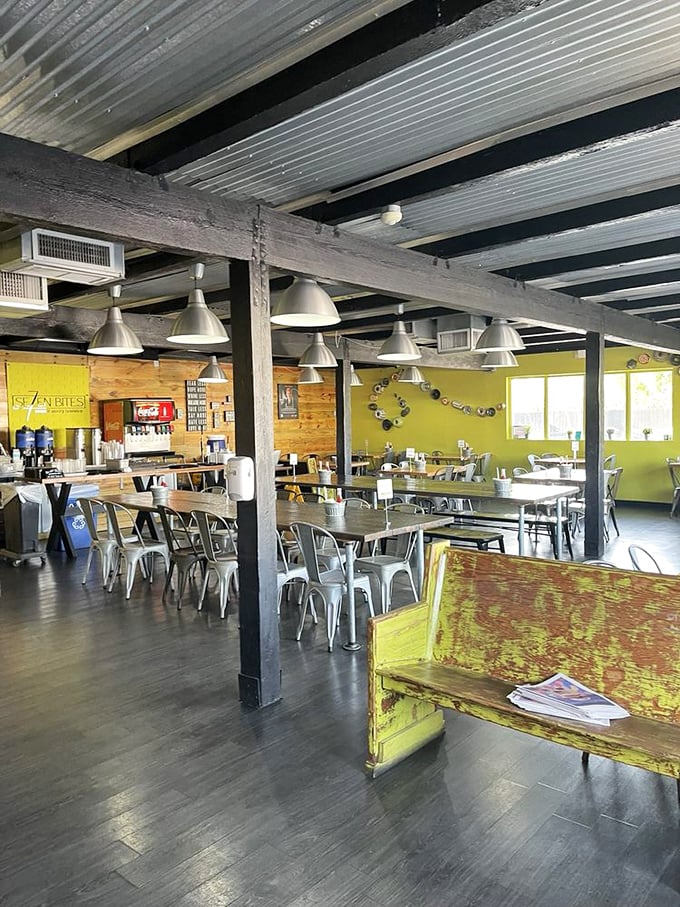 Industrial meets homey in this thoughtfully designed space where wooden accents, metal chairs, and communal tables create the perfect backdrop for culinary magic.