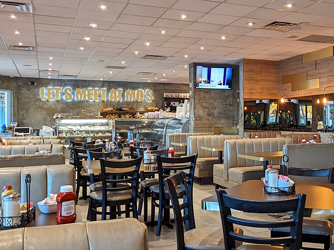 "LET'S MEET AT MO'S" isn't just a neon sign&mdash;it's a promise of comfort food paradise. The modern interior blends nostalgic deli vibes with contemporary Florida brightness.