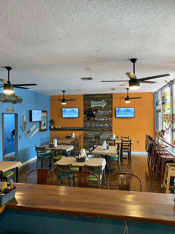 Bright orange walls and weathered wood accents create that perfect "Old Florida meets modern comfort" vibe that makes you instantly feel like a regular.