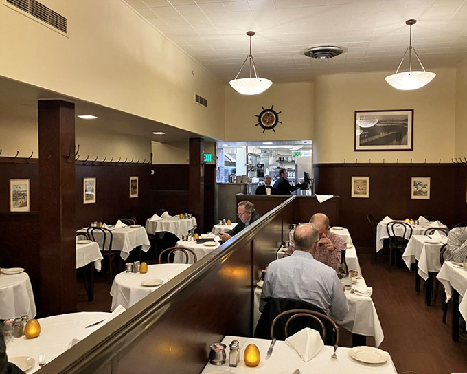 Classic white tablecloths and dark wood paneling create the perfect stage for seafood stardom, where business deals and family celebrations have unfolded for generations.