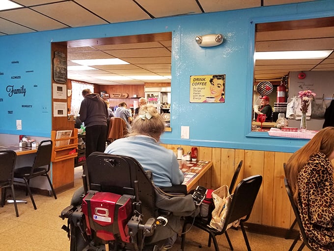 Blue walls and wood paneling create that classic diner atmosphere where regulars become family and newcomers feel instantly welcome.