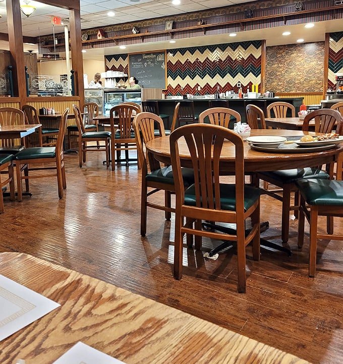 Wooden chairs, warm lighting, and that distinctive chevron wall pattern &ndash; this isn't interior design, it's a time machine to simpler, delicious days.