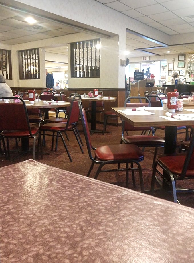 Classic diner charm at its finest &ndash; red vinyl chairs and wood paneling create the perfect backdrop for morning coffee rituals.