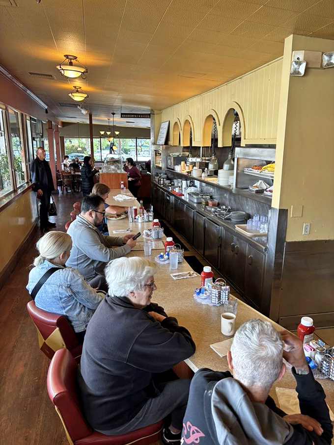 The counter seating at Tallyrand offers front-row tickets to the culinary show, where regulars and newcomers alike witness comfort food magic in action.