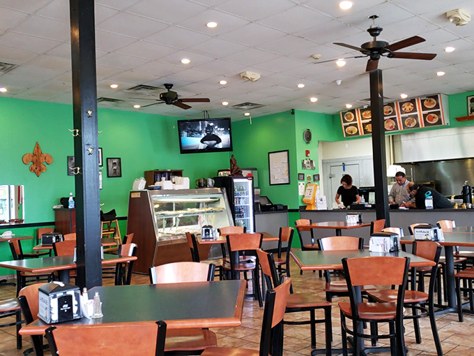 Step inside where bright walls and orange chairs create an atmosphere that says "relax, you're about to eat really well."