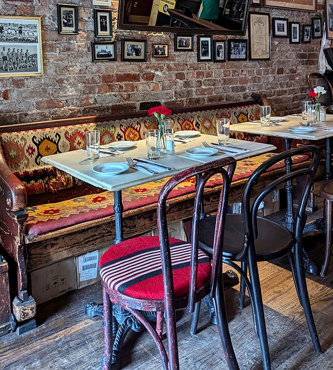 Exposed brick walls meet colorful traditional textiles in this cozy dining room where every table feels like you're eating at a Serbian grandmother's house.