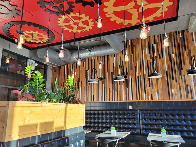 The ceiling's vibrant gear motif and warm wooden accents create an atmosphere that's equal parts industrial chic and neighborhood cozy&mdash;like a hug from a very stylish friend.