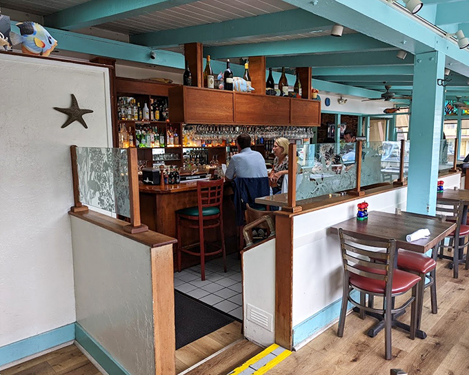 The bar area beckons with turquoise beams overhead&mdash;nautical charm without trying too hard, exactly as a seafood joint should be.