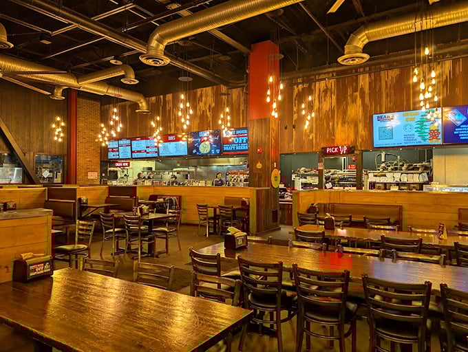 Industrial chic meets comfort food haven—wooden walls and hanging lights create the perfect backdrop for serious barbecue business.