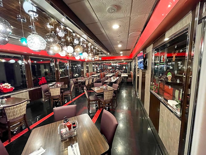 Red accents and hanging pendant lights create that perfect nostalgic glow where everyone looks like they're in a Norman Rockwell painting.