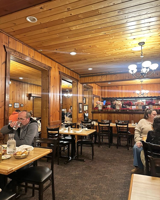Warm pine paneling and soft lighting create the perfect backdrop for family gatherings, where conversations flow as freely as the refills.