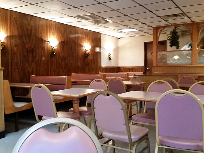 Wood paneling and purple chairs create a timeless atmosphere where comfort trumps trends every single time.