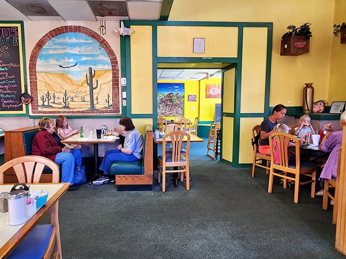 Yellow walls adorned with desert murals transport diners from Kansas plains to southwestern landscapes, while wooden booths invite you to settle in for the long haul.