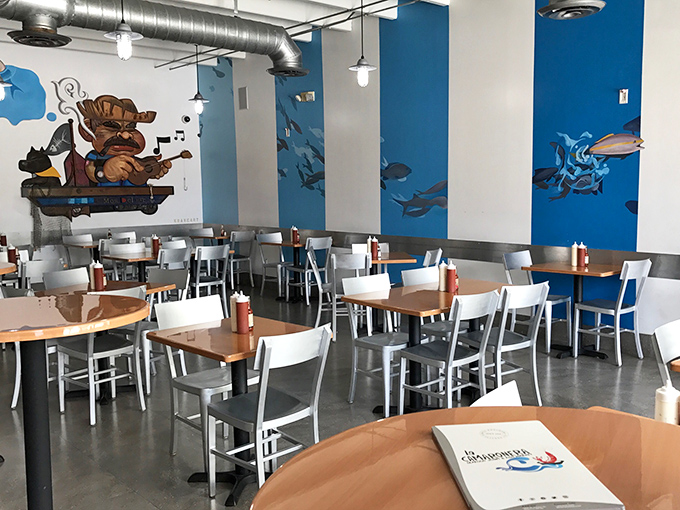 La Camaronera's casual dining room features ocean-blue murals and simple furnishings, creating an unpretentious atmosphere where the seafood remains the star.