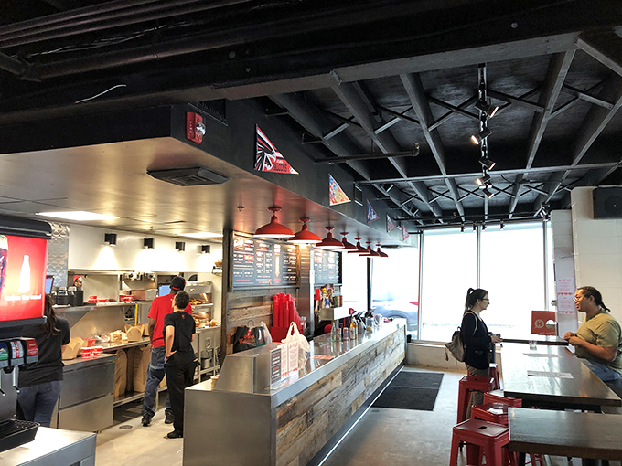 Industrial-chic meets Southern hospitality inside, where the exposed ceiling and red pendant lights set the stage for the flavor fireworks about to happen.