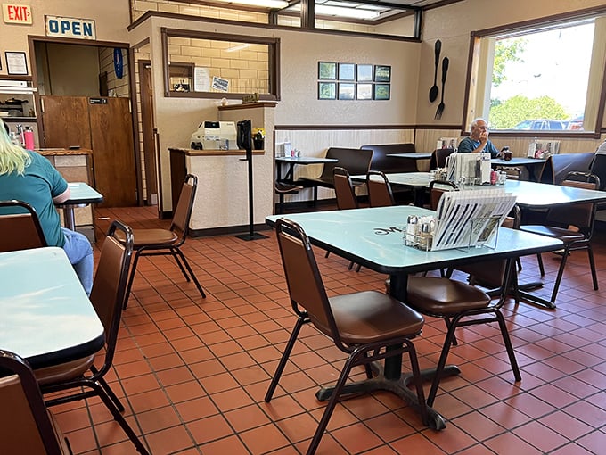 Classic diner simplicity at its finest &ndash; mint-green tables, terra cotta floors, and not an edison bulb in sight. Just honest comfort.