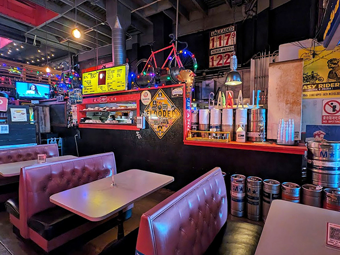 Inside Garaje, vintage booths and automotive decor create the perfect backdrop for serious eating. The neon-lit bicycle suggests you might need to pedal home after indulging.