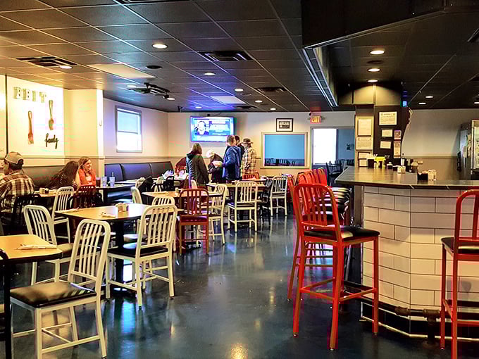 Red and silver chairs pop against wooden tables in this cozy dining room where strangers become friends and calories don't count.