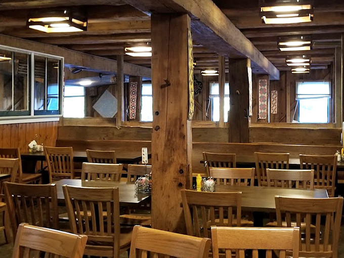 Massive wooden beams frame the dining experience, creating an atmosphere that whispers "this place has seen more Sunday dinners than a church potluck committee."