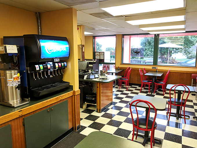 Modern elegance meets breakfast comfort inside, where pendant lights cast a golden glow over marble tables and cozy booths.