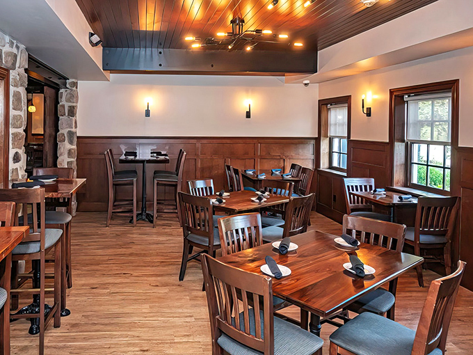Warm wooden wainscoting and perfectly spaced tables create that rare dining atmosphere where conversation flows as smoothly as the wine.