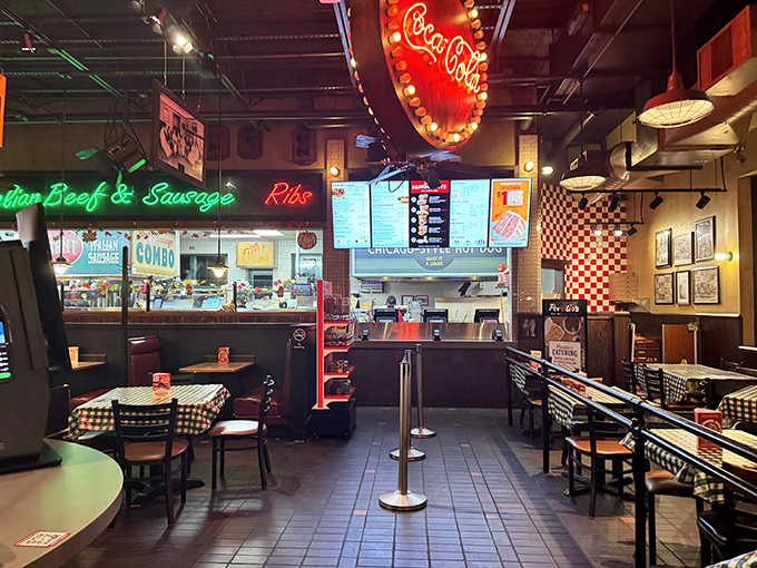 Step inside and the nostalgic diner aesthetic hits you like a warm hug. Red neon, checkered tablecloths, and the promise of deliciousness await.
