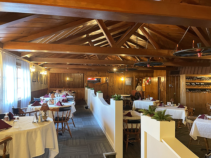 Exposed wooden beams, white tablecloths, and warm paneling create that perfect sweet spot between "special occasion" and "comfortable enough to actually enjoy your meal."