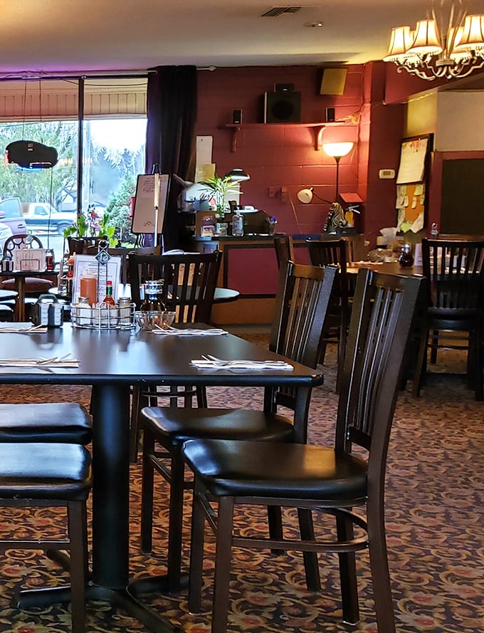 Warm red walls and wooden chairs create that "everybody knows your name" vibe. The kind of place where coffee refills arrive before you ask.