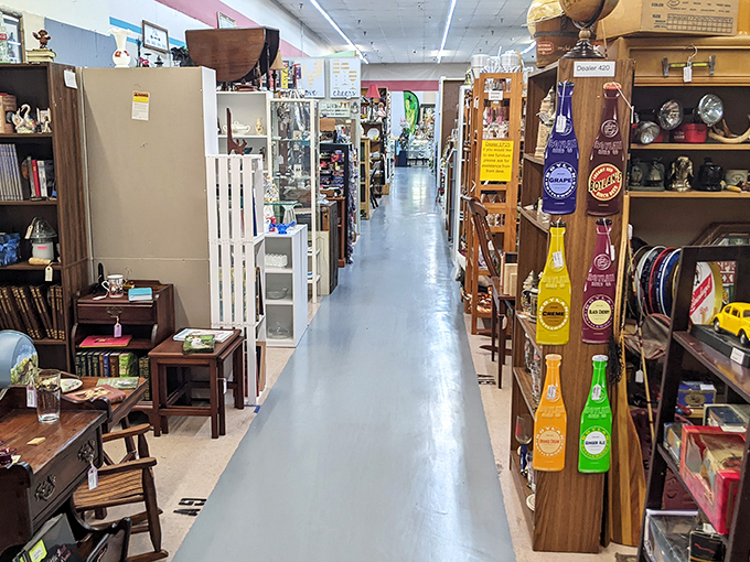 Aisles stretch like roads to different decades, with vendor booths lining both sides and that signature blue floor guiding you through this labyrinth of memories.