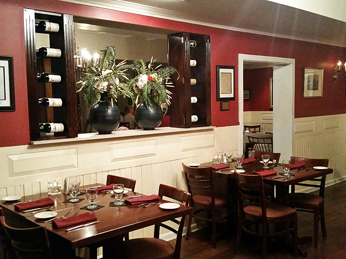 Rich burgundy walls and elegant wood finishes create an atmosphere where history meets luxury. Thomas Jefferson would approve of this dining room.