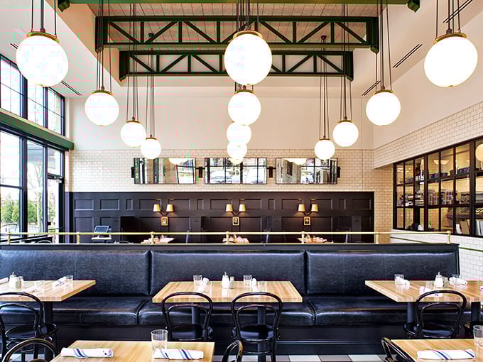 Soaring ceilings, globe lights, and leather banquettes create a space that feels both timeless and thoroughly modern&mdash;New York deli meets Atlanta sophistication.